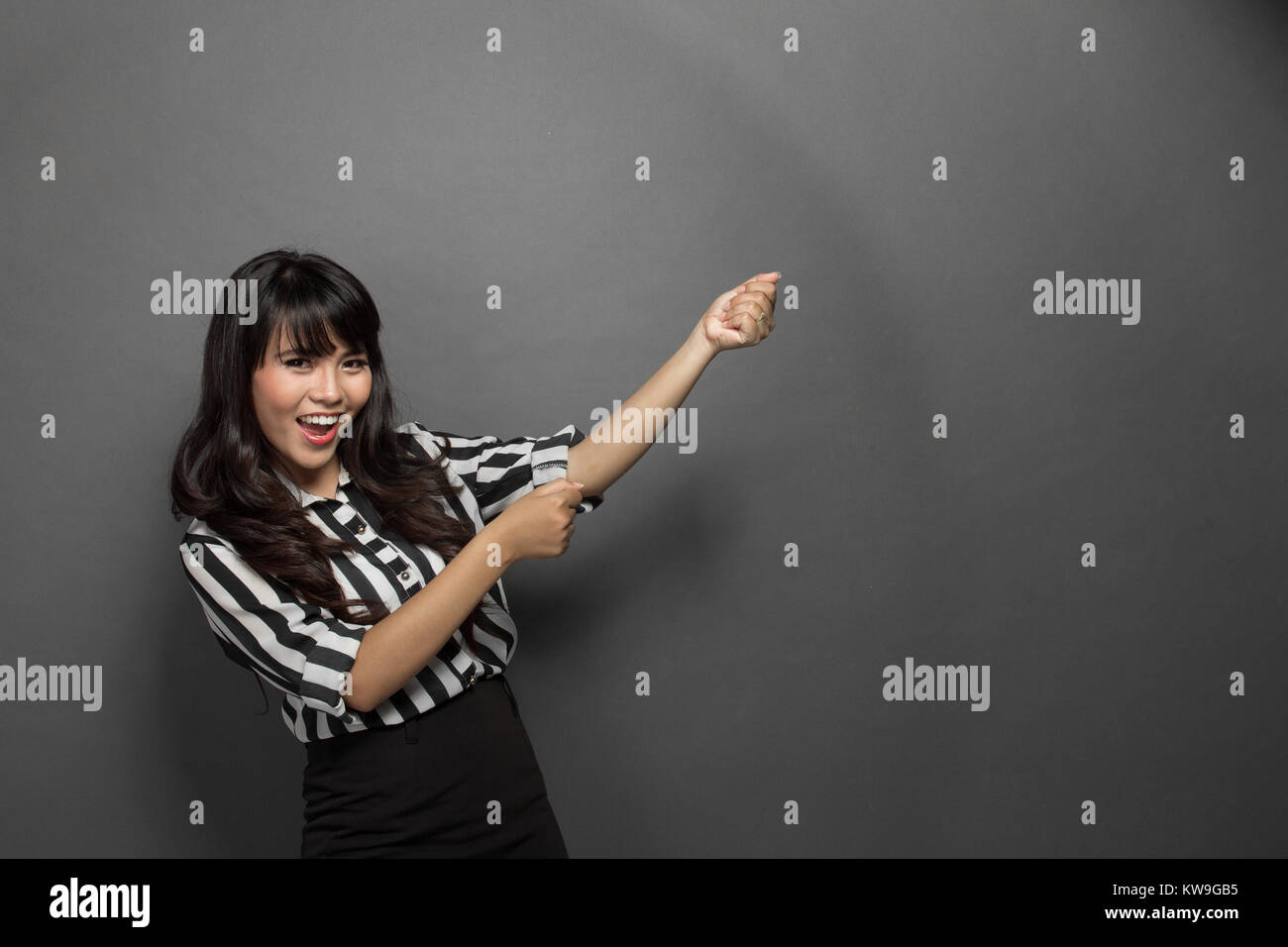 portrait of a young businesswoman pulling out something Stock Photo - Alamy