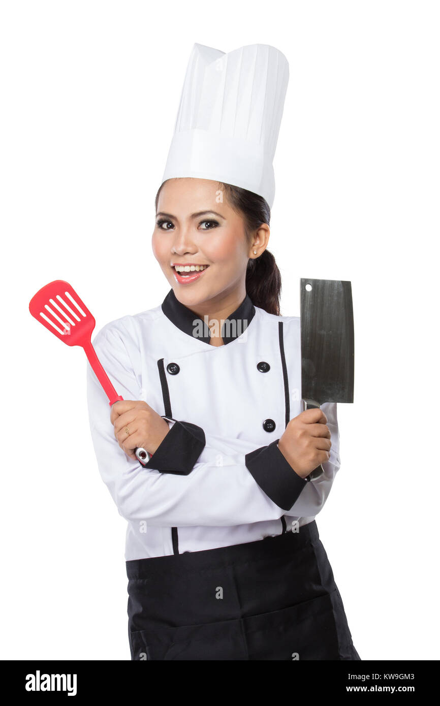 A young, female chef in a traditional hat and coat isolated on white ...