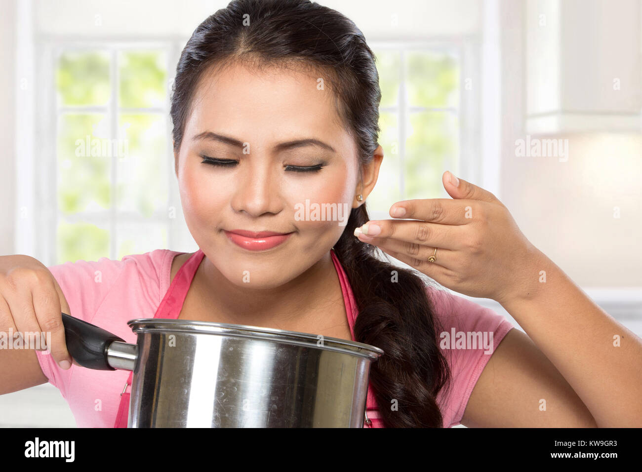 young woman Chef hold a pan for cooking and smell of cooking Stock ...