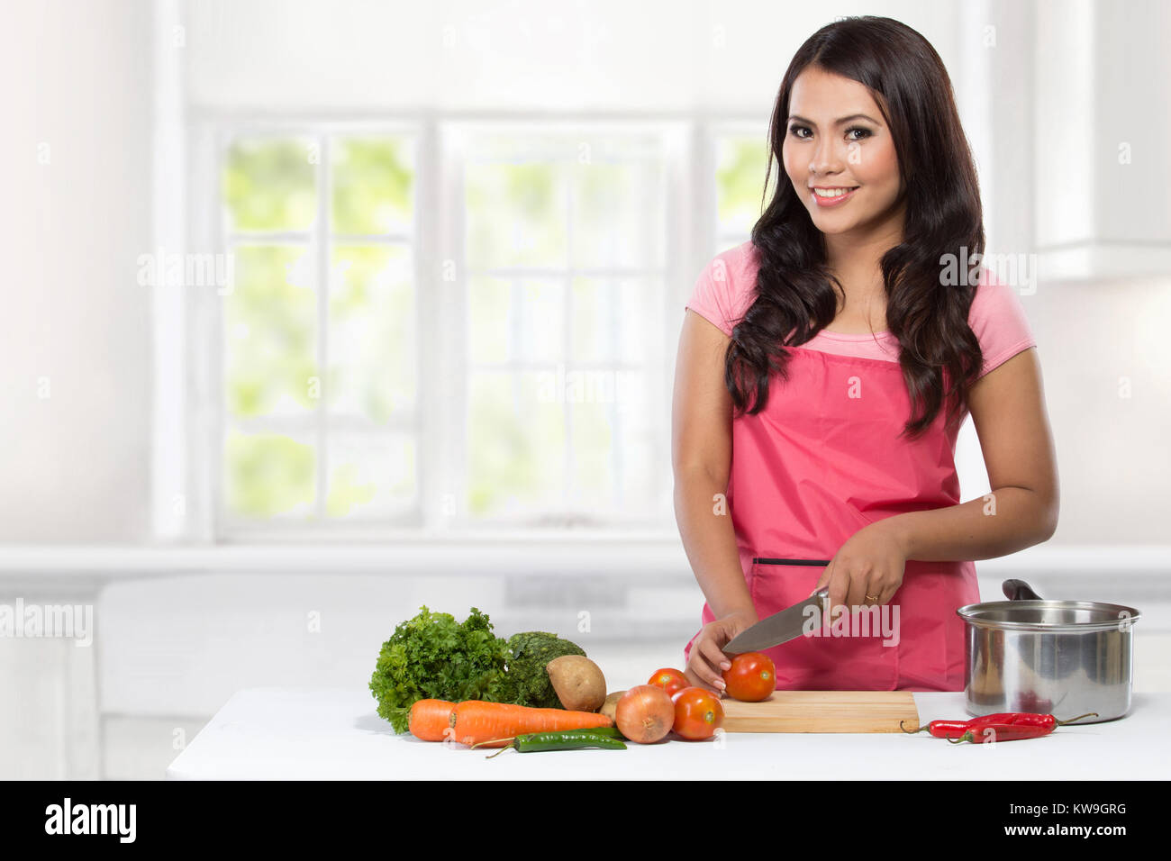 Young Woman Cooking in the kitchen. Healthy Food Diet. Cooking At Home. Prepare Food Stock Photo ...