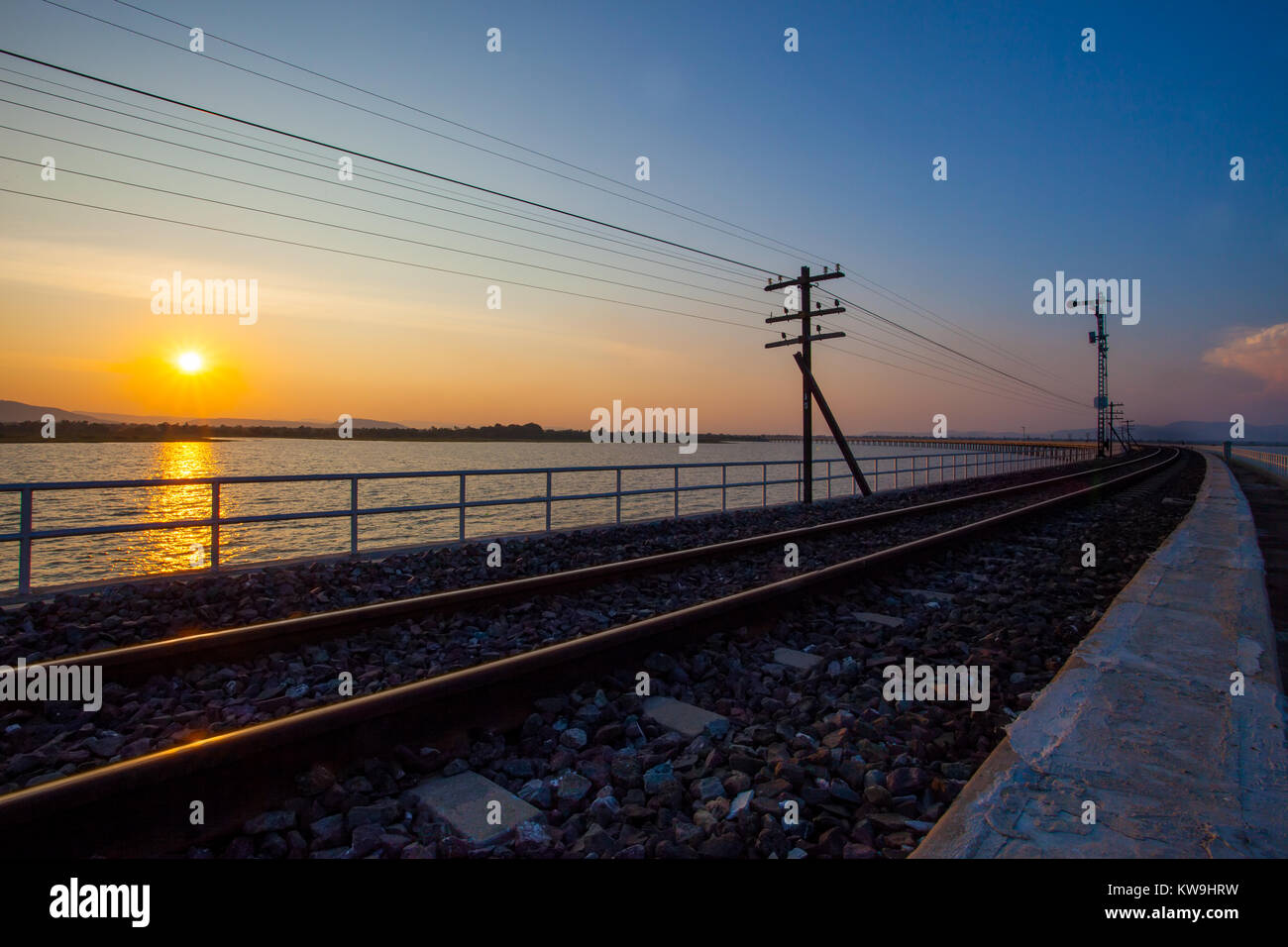 rail way track over water reservoir and beautiful sun set sky Stock ...
