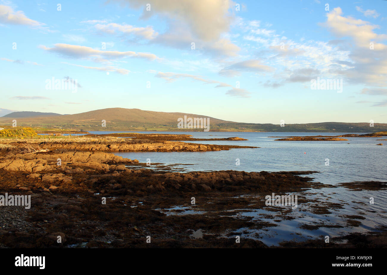 Beautiful body of water watching the sunset during an Irish summer ...
