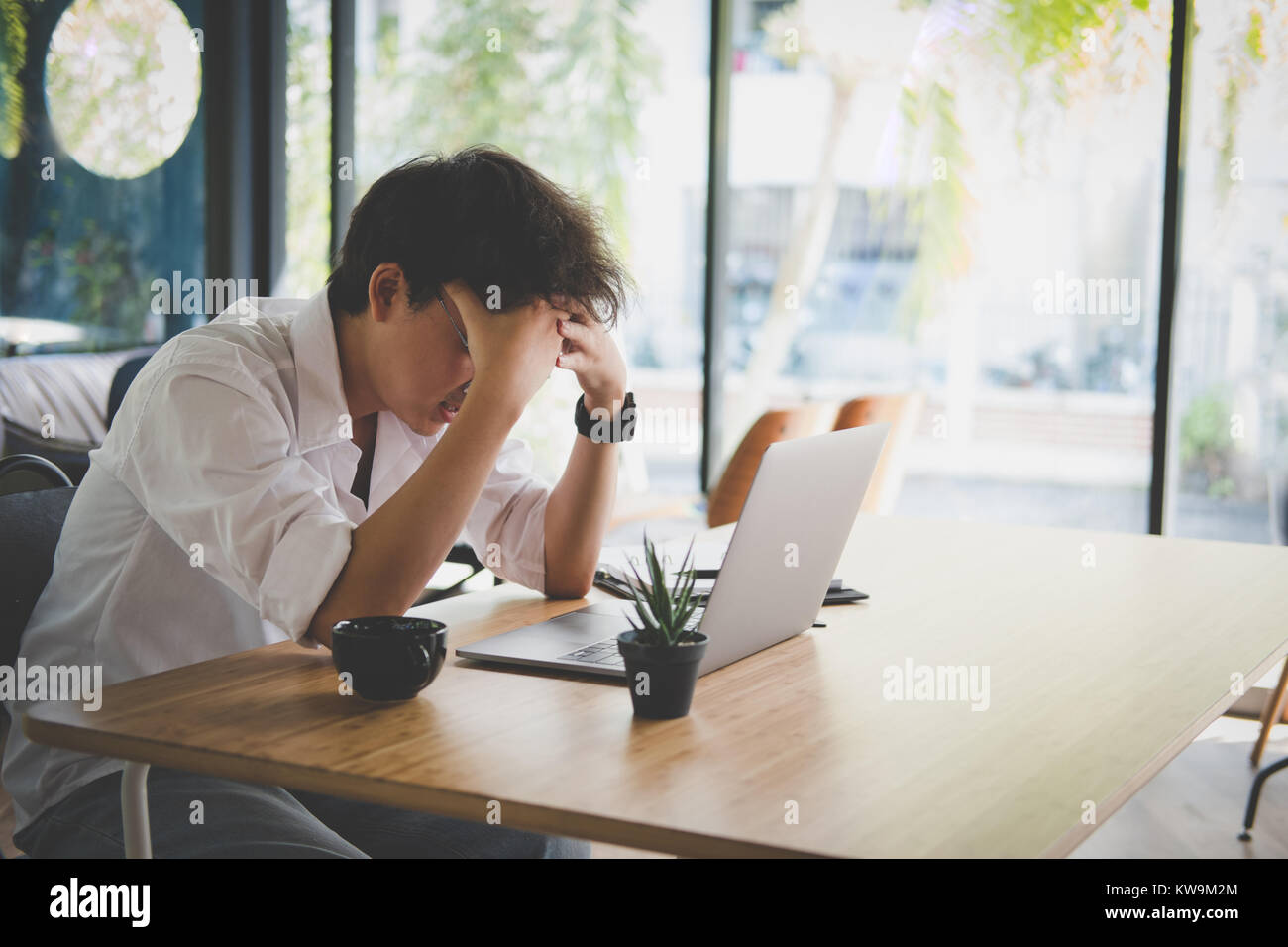 asian student using computer for learning leasson online at cafe ...