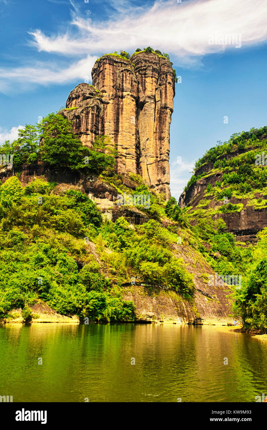 Rock formations lining the nine bend river or Jiuxi in Wuyishan or ...