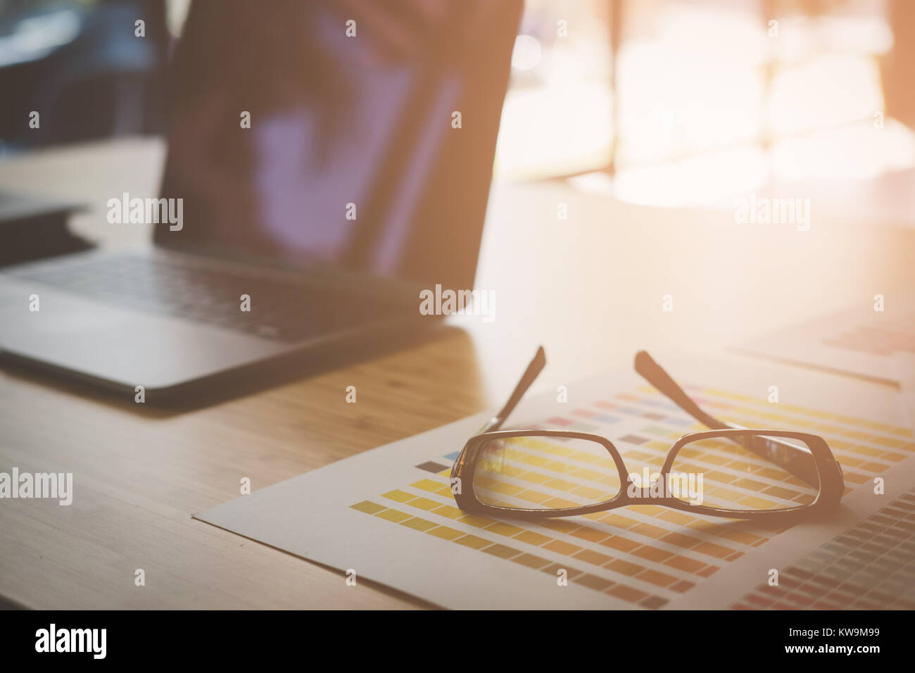 eyeglasses, color swatch sample on office desk. graphic designer ...