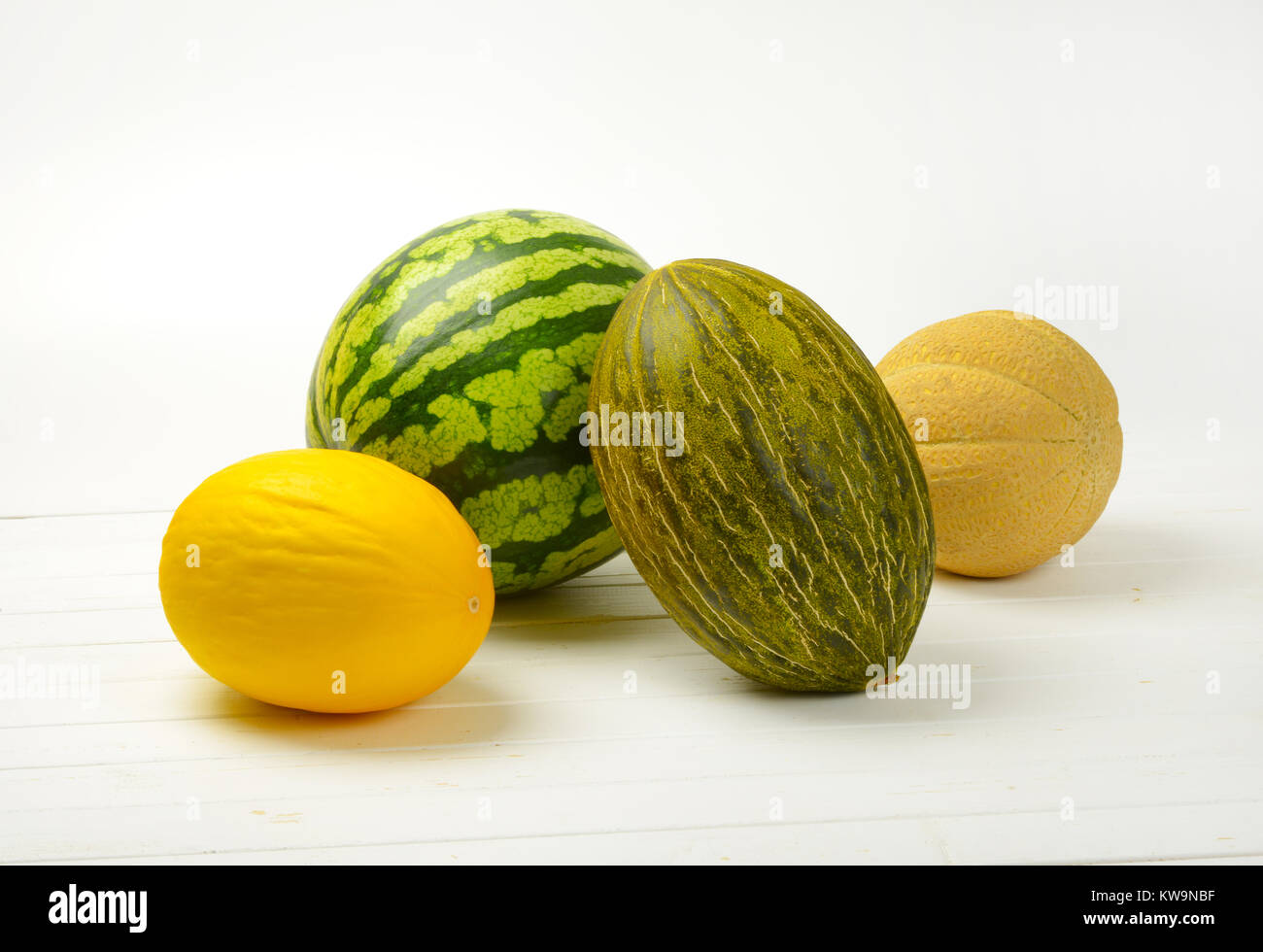 various types of melon on white wooden background Stock Photo - Alamy