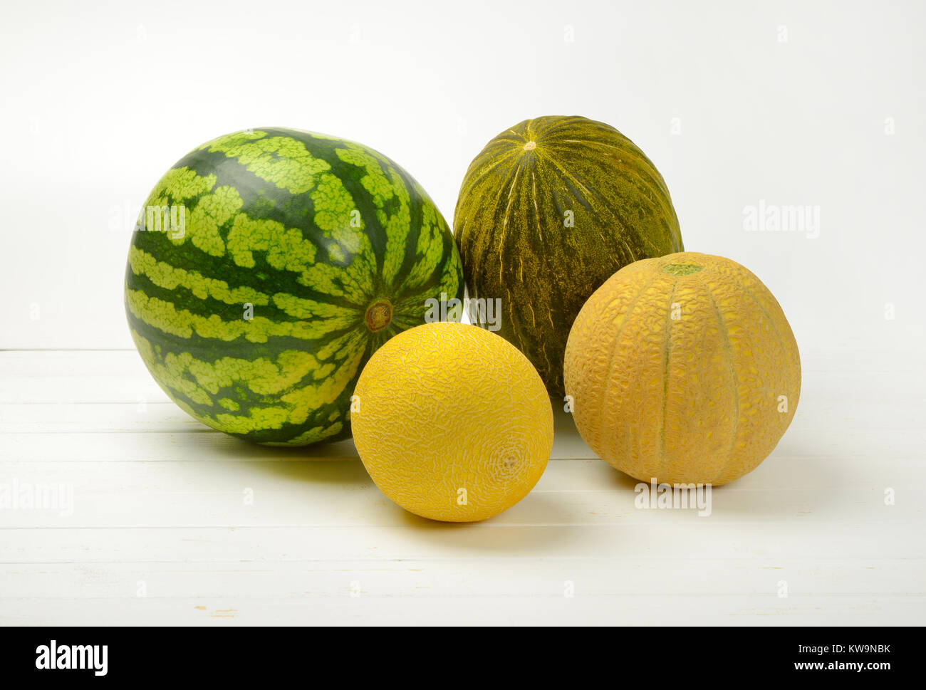 various types of melon on white wooden background Stock Photo - Alamy