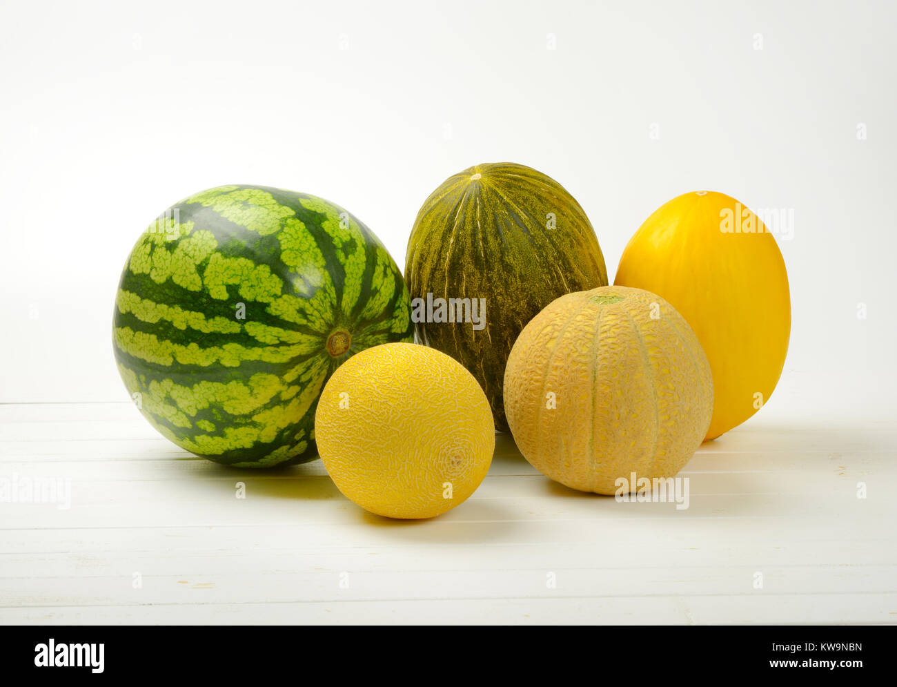 various types of melon on white wooden background Stock Photo - Alamy