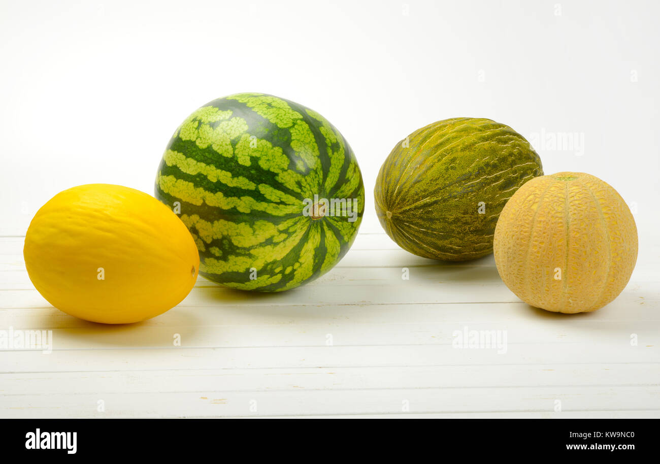 various types of melon on white wooden background Stock Photo - Alamy