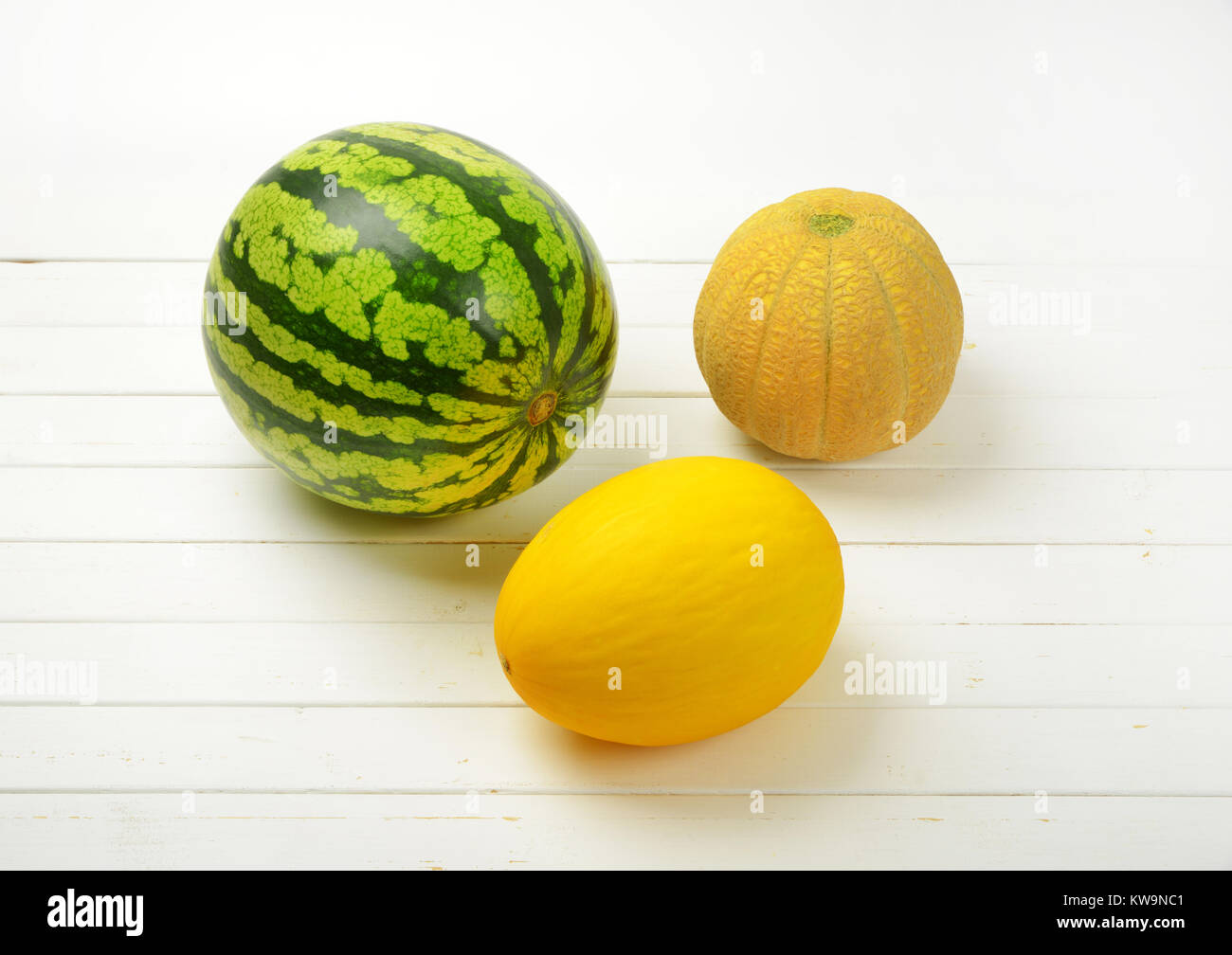 various types of melon on white wooden background Stock Photo - Alamy