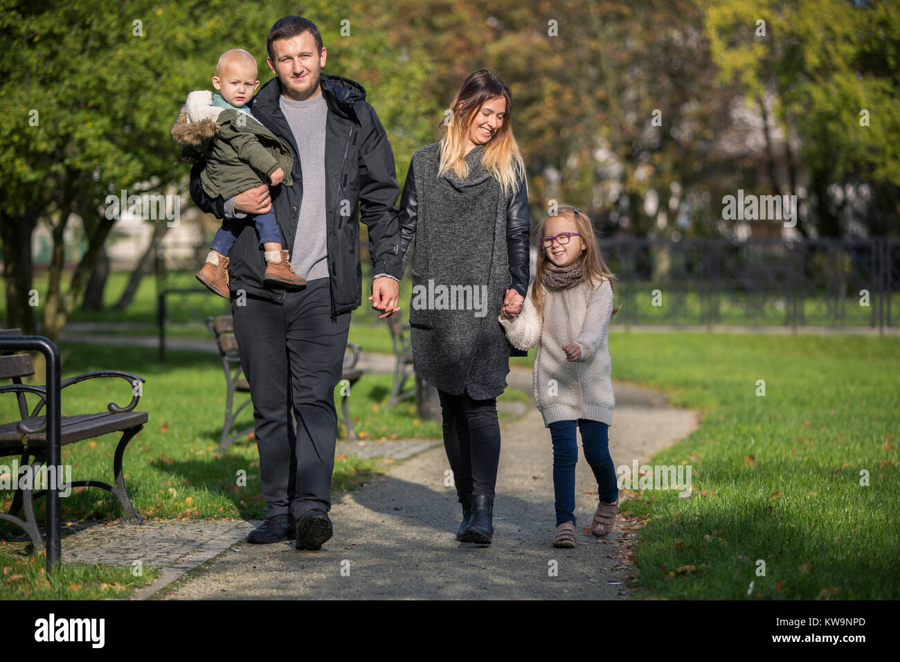 Family walk in the park, fall season Stock Photo - Alamy