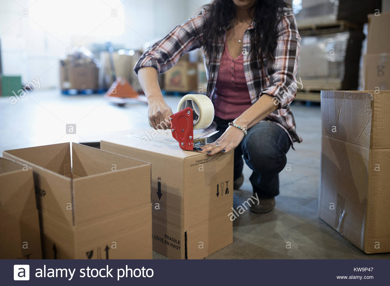 Person using tape gun hi-res stock photography and images - Alamy