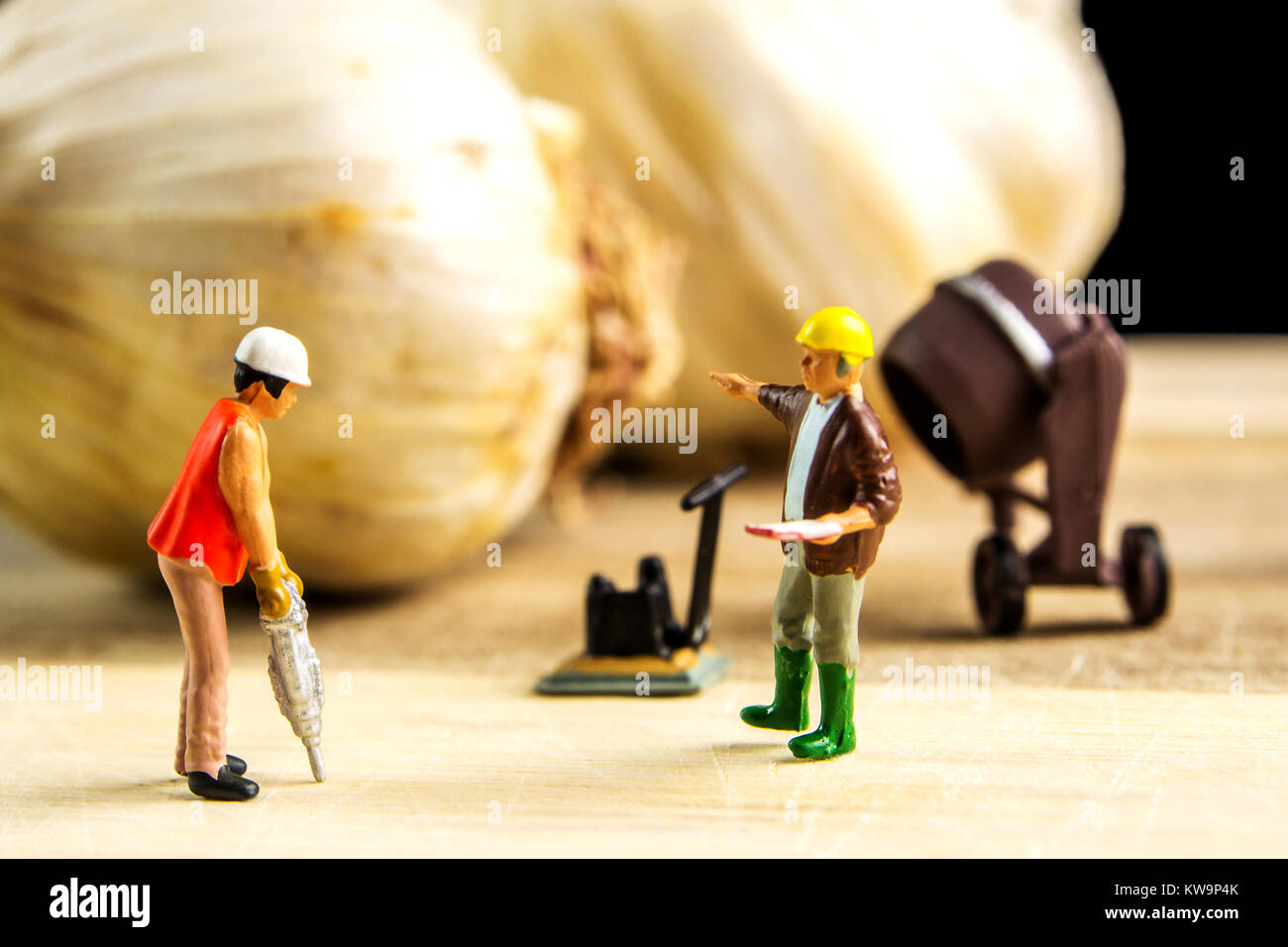 miniature figurines working hard together in order to make garlic best ...