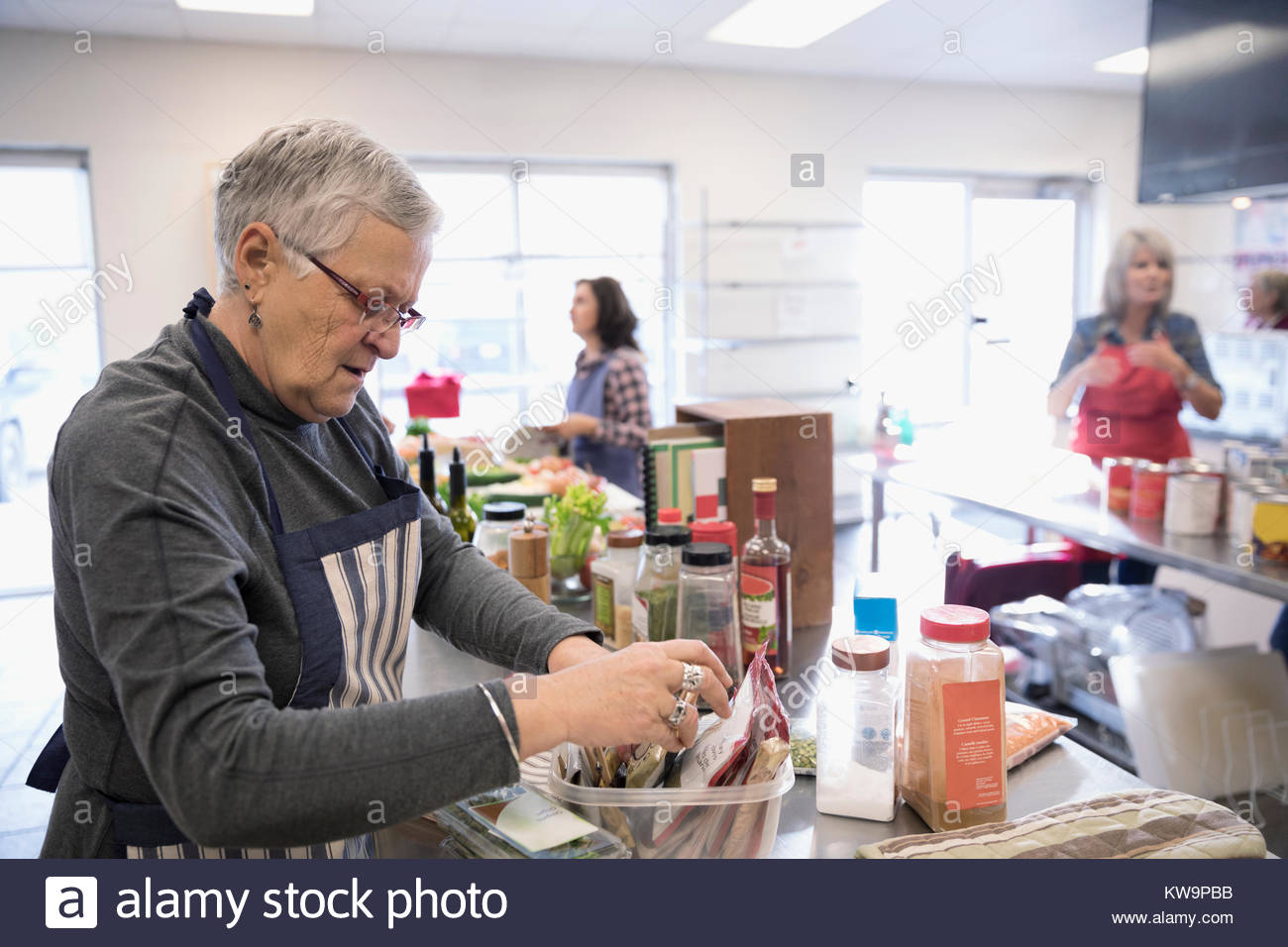 Female volunteer cooking in soup kitchen Stock Photo - Alamy