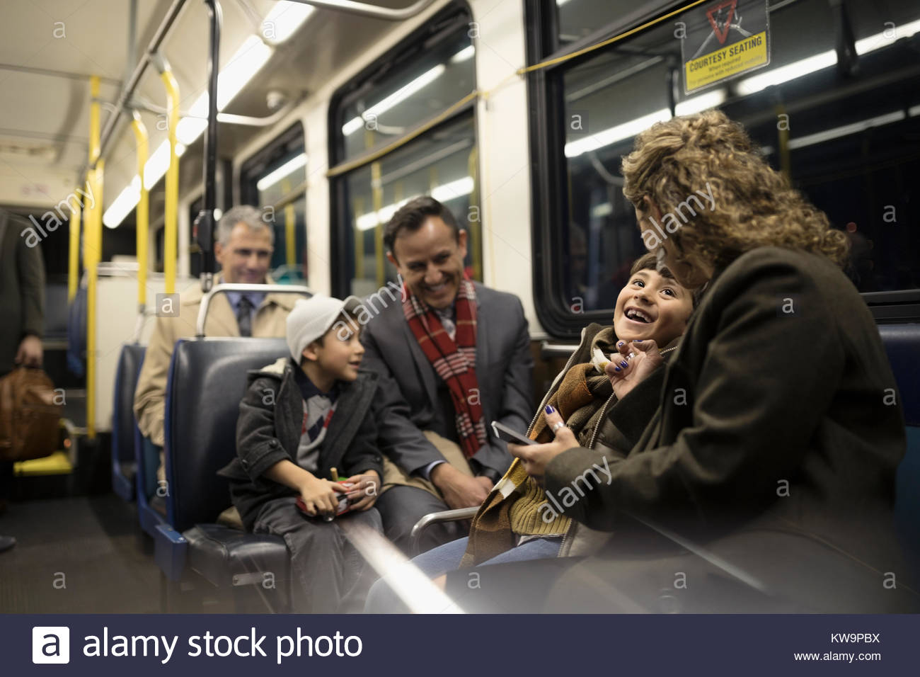 Latino family riding bus Stock Photo - Alamy