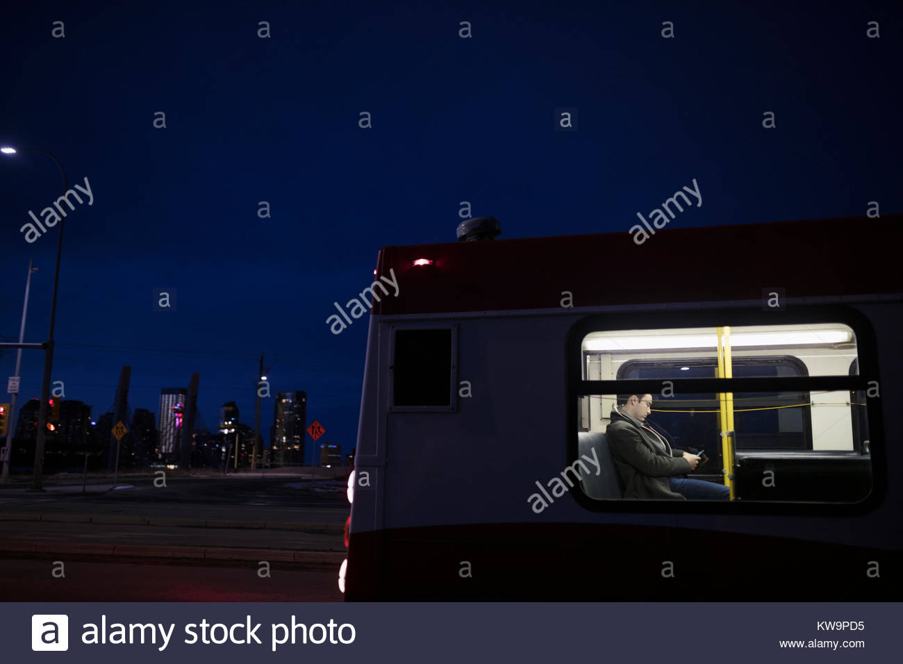 Man commuting night city looking phone hi-res stock photography and ...