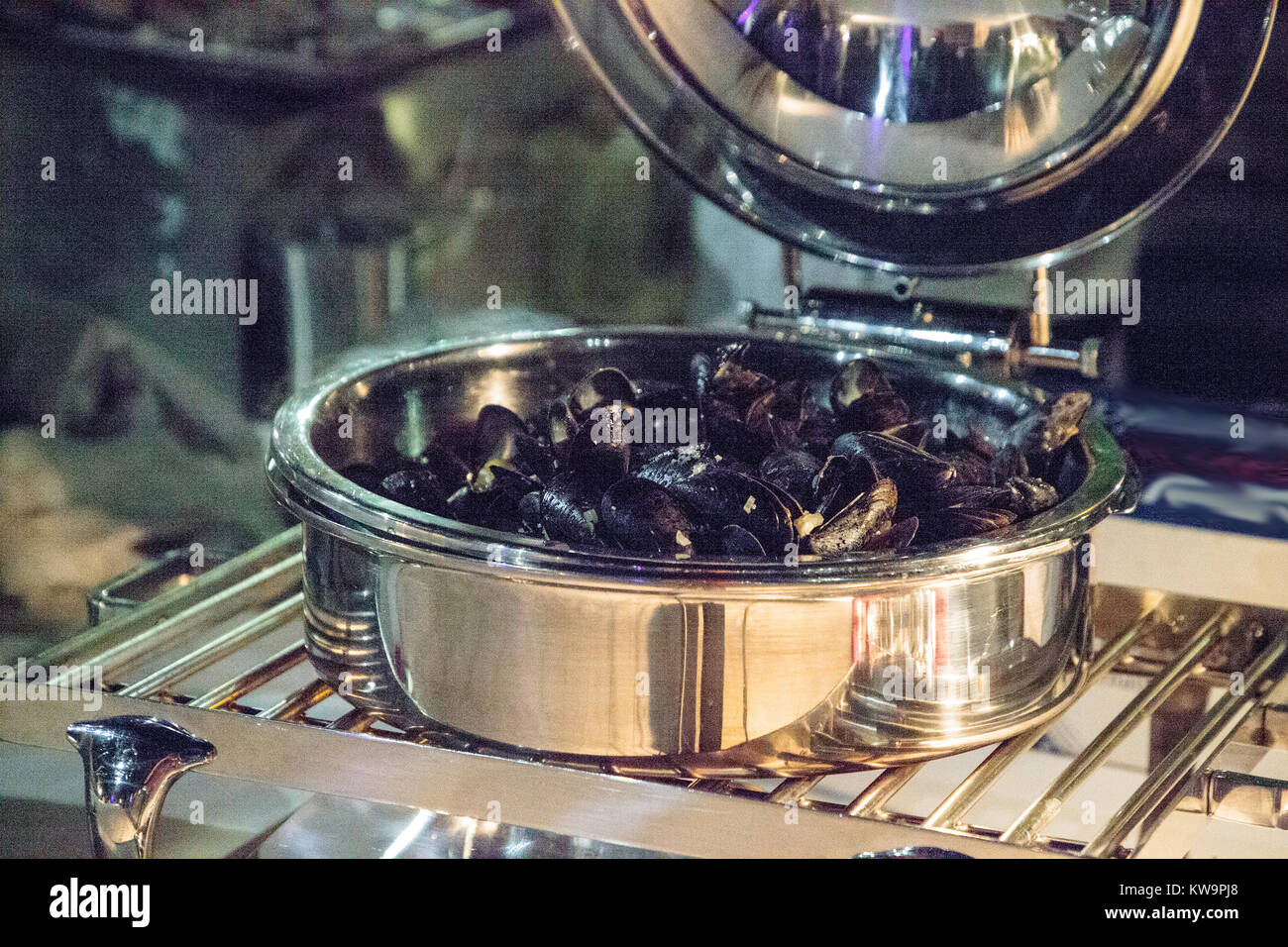 Muscles steamed in a black steamer in a kitchen Stock Photo - Alamy