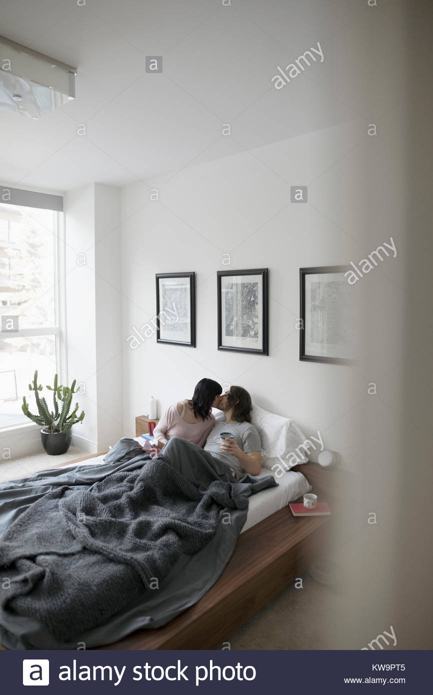 Romantic couple kissing in bed hi-res stock photography and images - Alamy