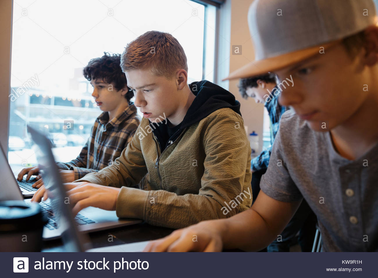 Boy typing laptop hi-res stock photography and images - Alamy