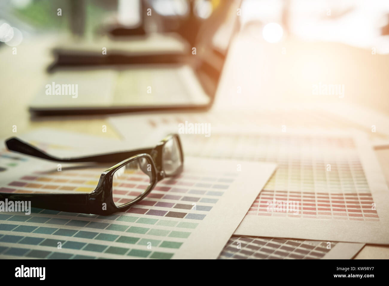 eyeglasses, color swatch sample on office desk. graphic designer ...