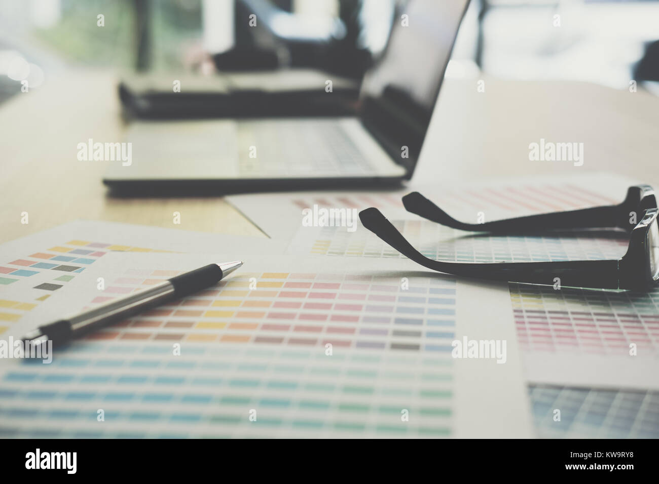eyeglasses, color swatch sample on office desk. graphic designer ...