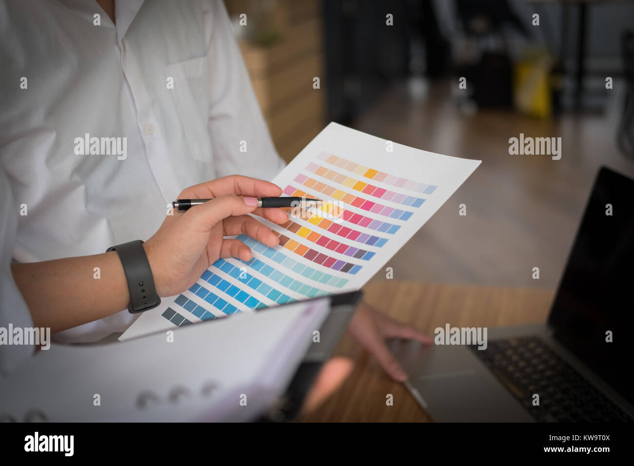 graphic or interior designer choosing color from swatch sample or ...