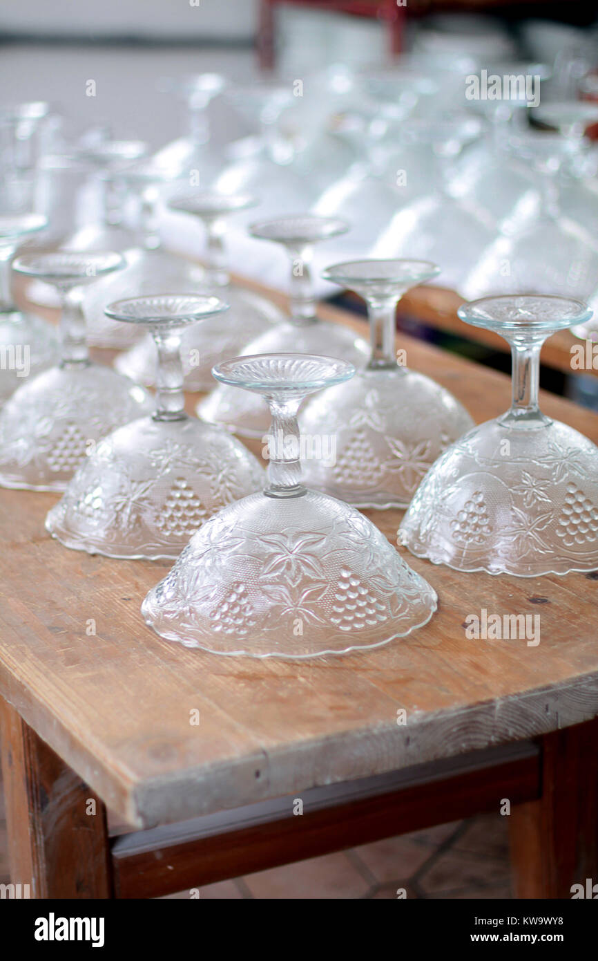 rows of glass vases for fruits and dessert in the restaurant kitchen ...