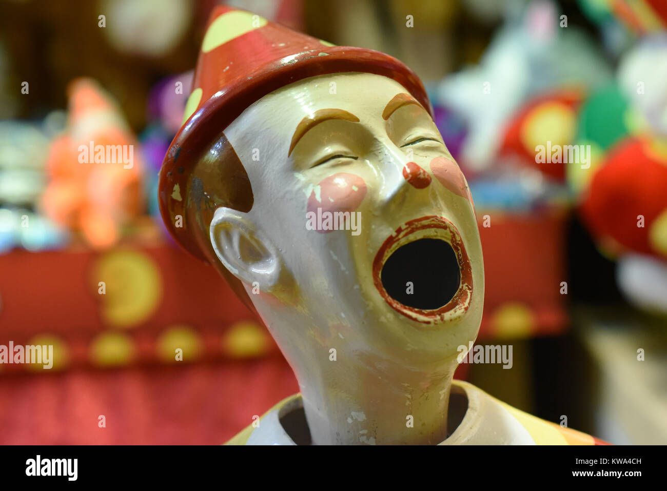 Brightly coloured laughing clowns at an amusement park Stock Photo - Alamy