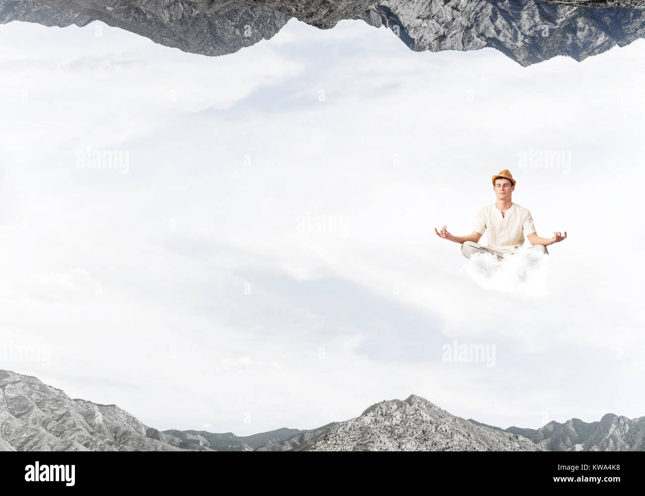 Young man keeping eyes closed and looking concentrated while meditating ...