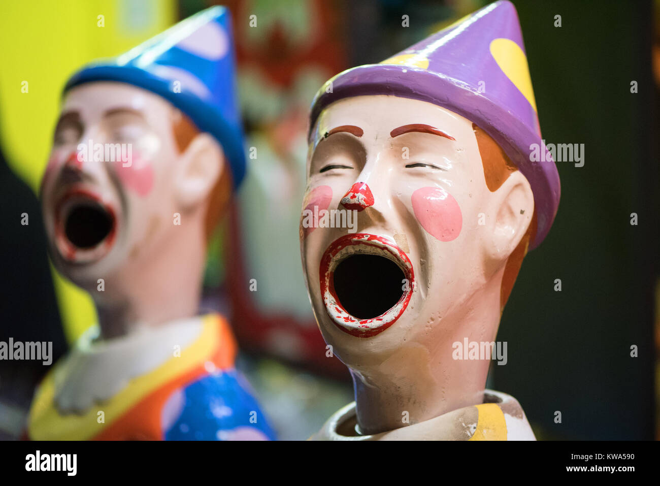 Brightly coloured laughing clowns at an amusement park Stock Photo - Alamy