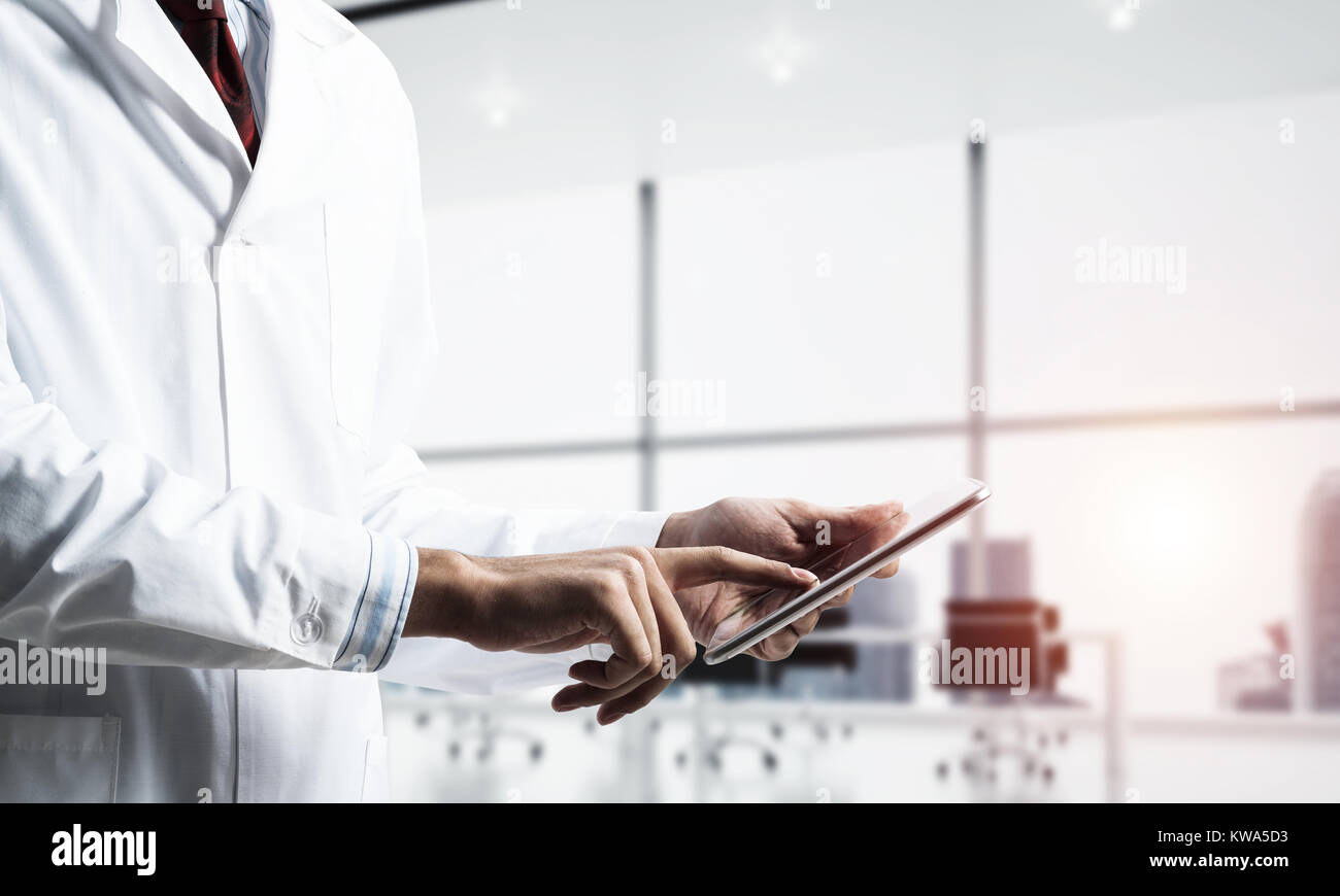 Cropped image of confident doctor in white sterile coat standing inside ...