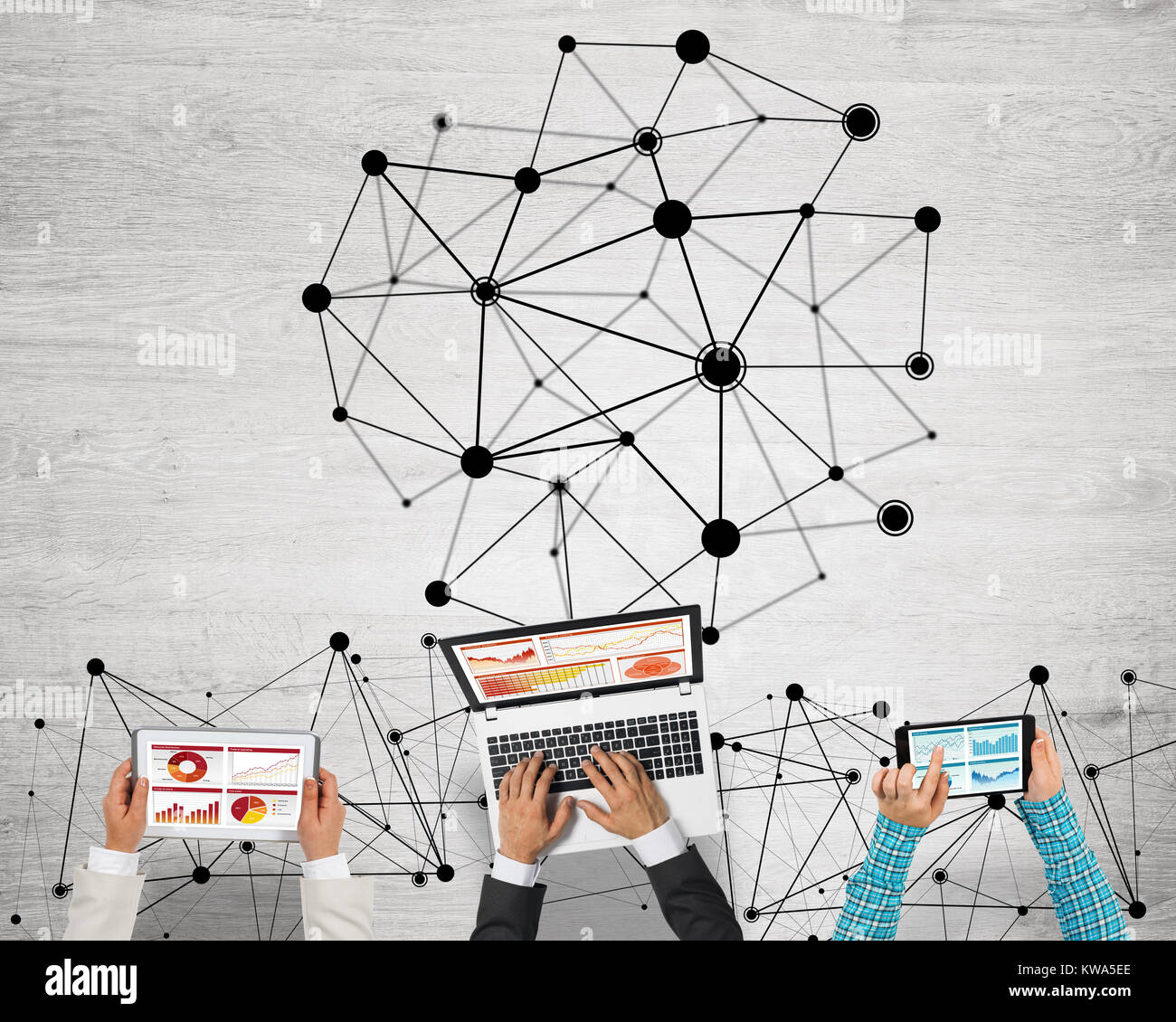 Group of three people with devices in hands working together as symbol ...