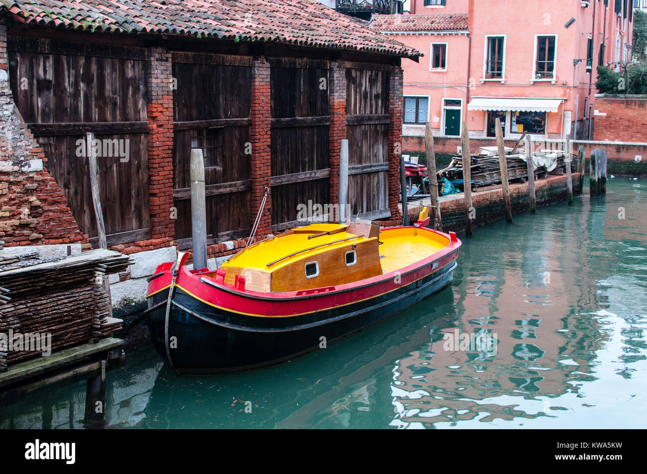 colorful small boats for transport in a canal of Venice Stock Photo - Alamy
