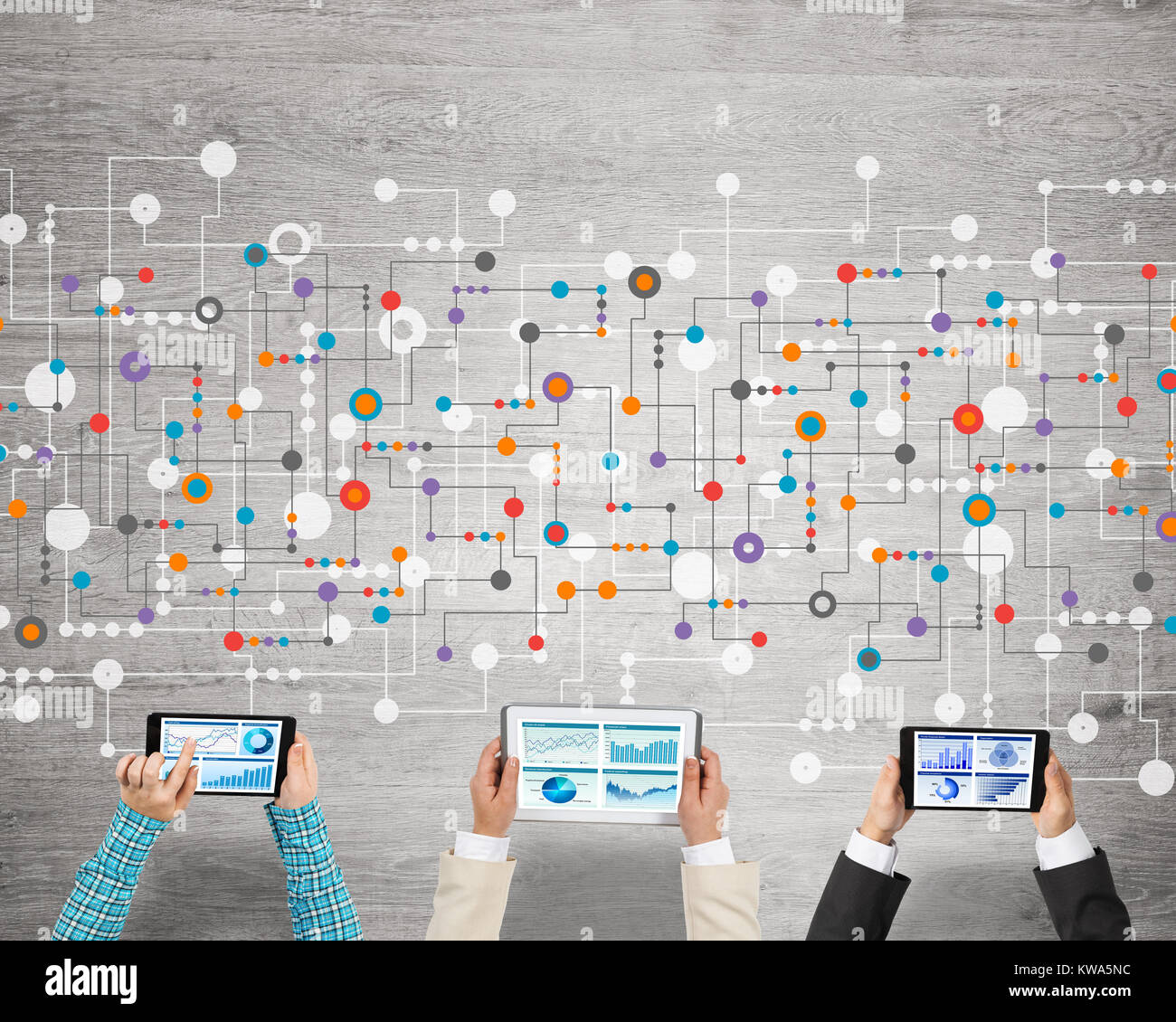 Group of three people with devices in hands working together as symbol ...