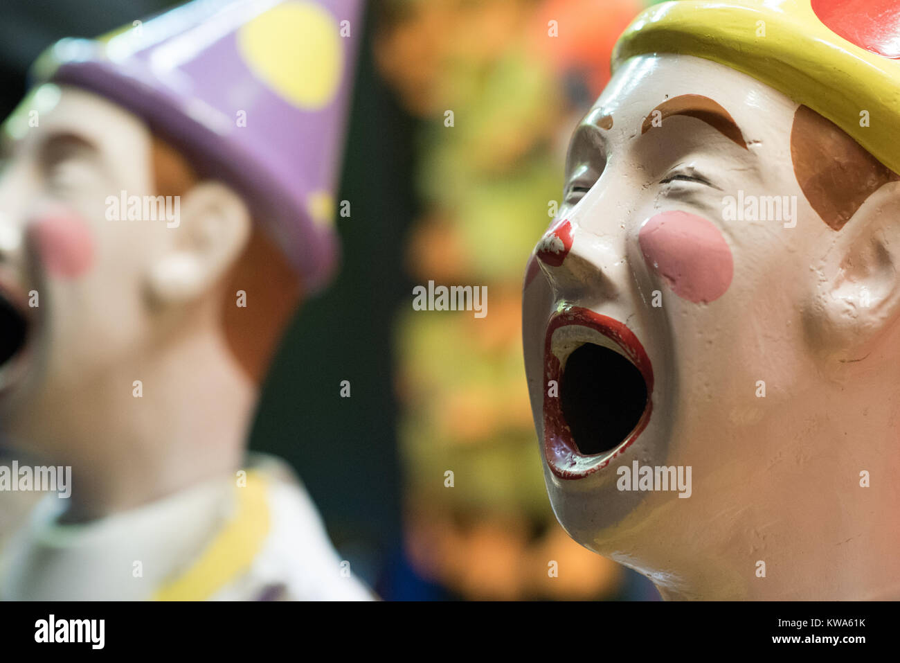 Brightly coloured laughing clowns at an amusement park Stock Photo - Alamy