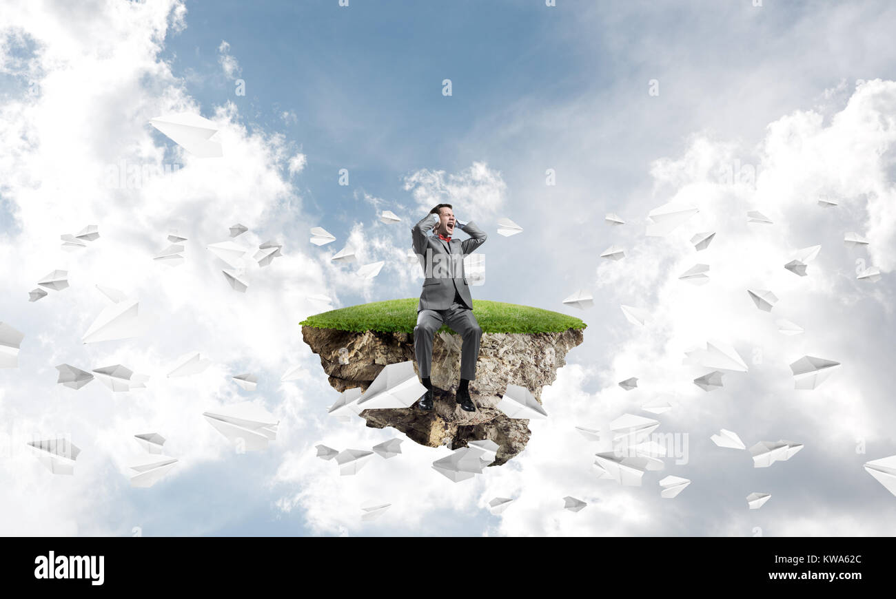 Young man in sky dont want to hear anything and paper planes fly around ...