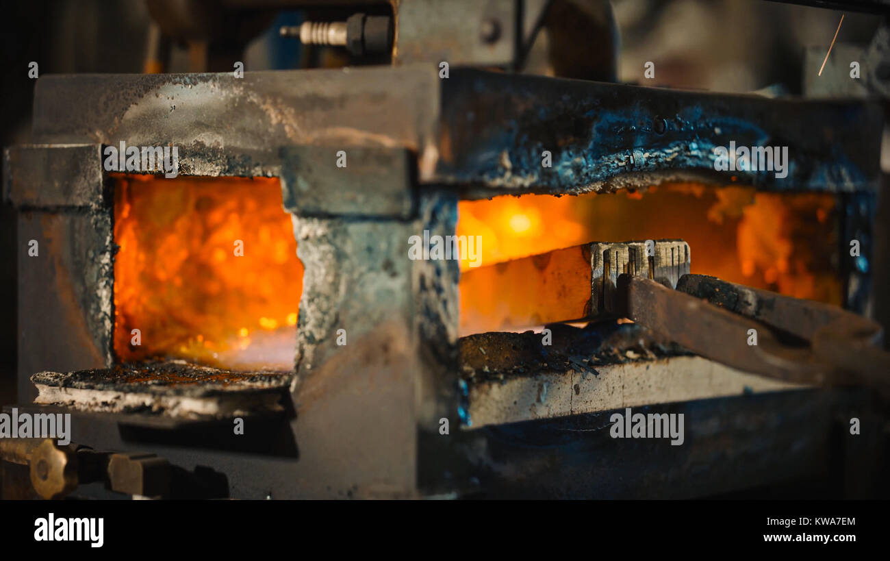 Detail of a furnace where a piece of metal is heated to be worked Stock ...