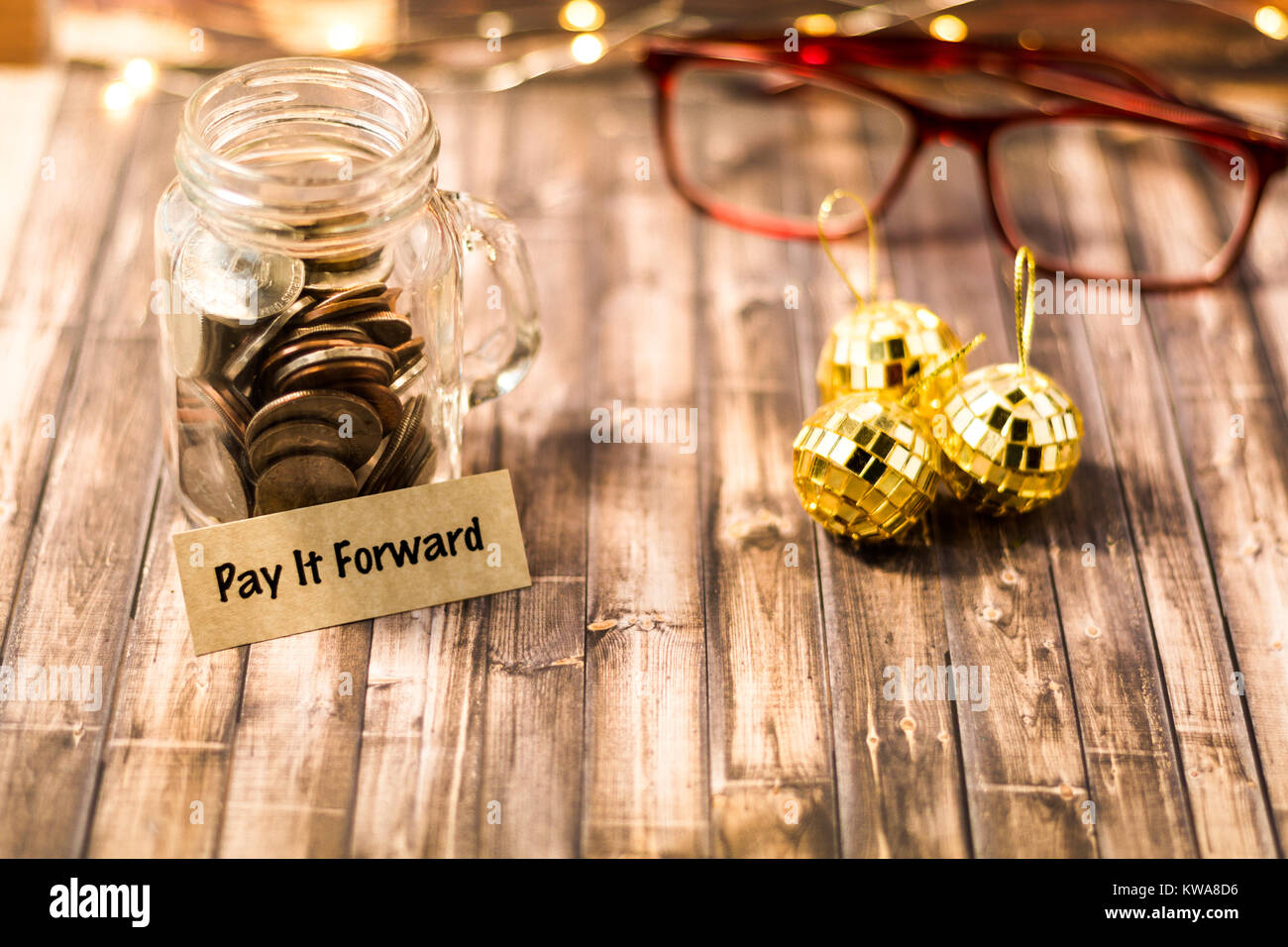 Pay it Forward money jar savings motivational concept on wooden board ...