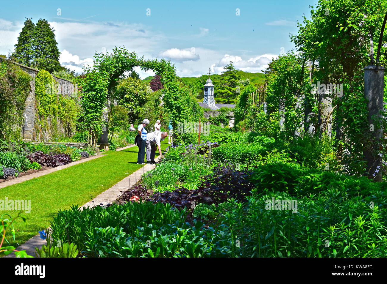 Visitors admiring the gardens at Dyffryn, a National Trust property in ...