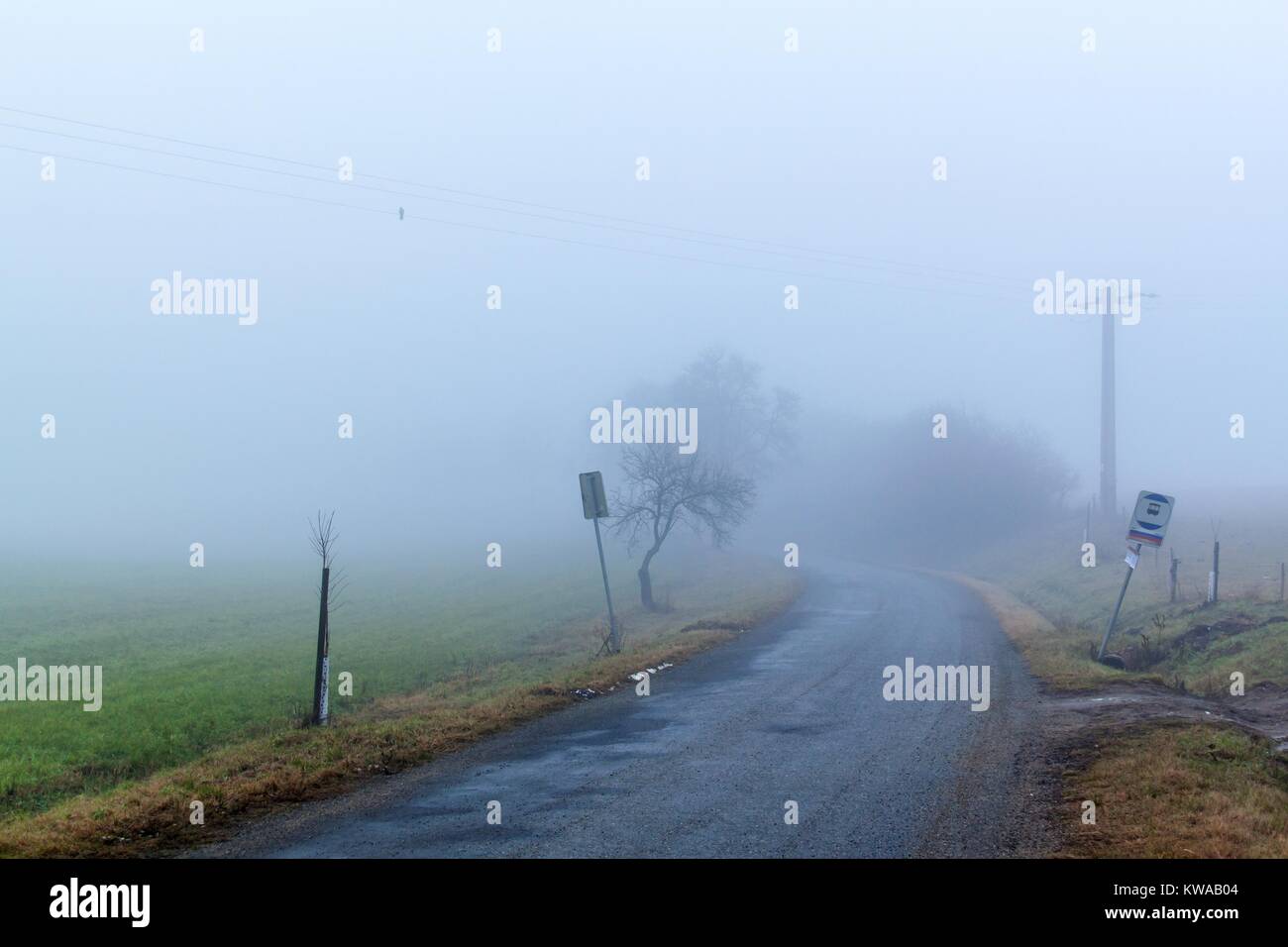 Deserted country road in fog. Foggy weather. Scary Way Stock Photo - Alamy