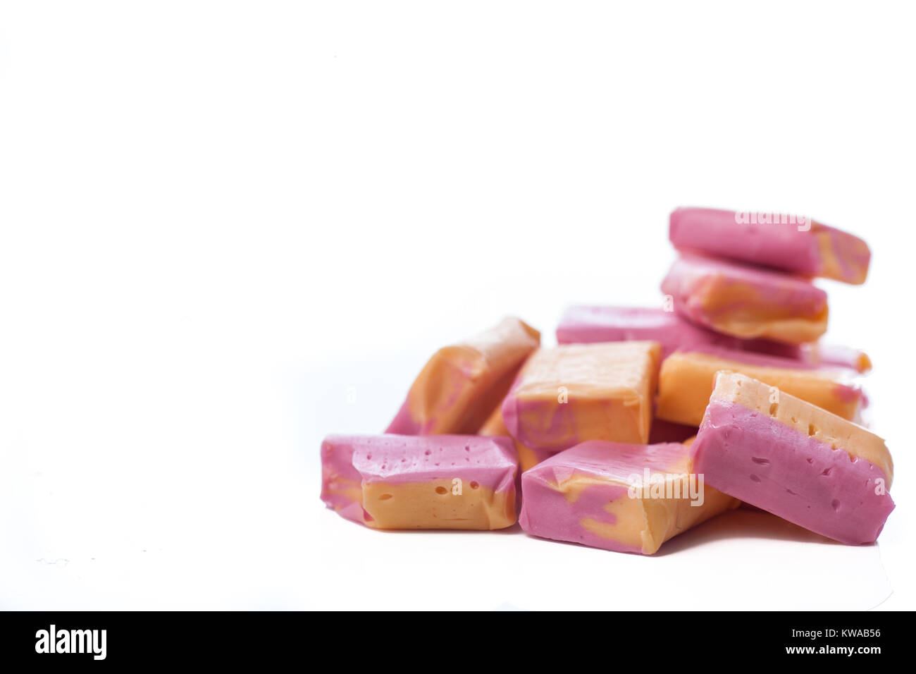 Fruit salad flavor candy chews on white background with copy space ...