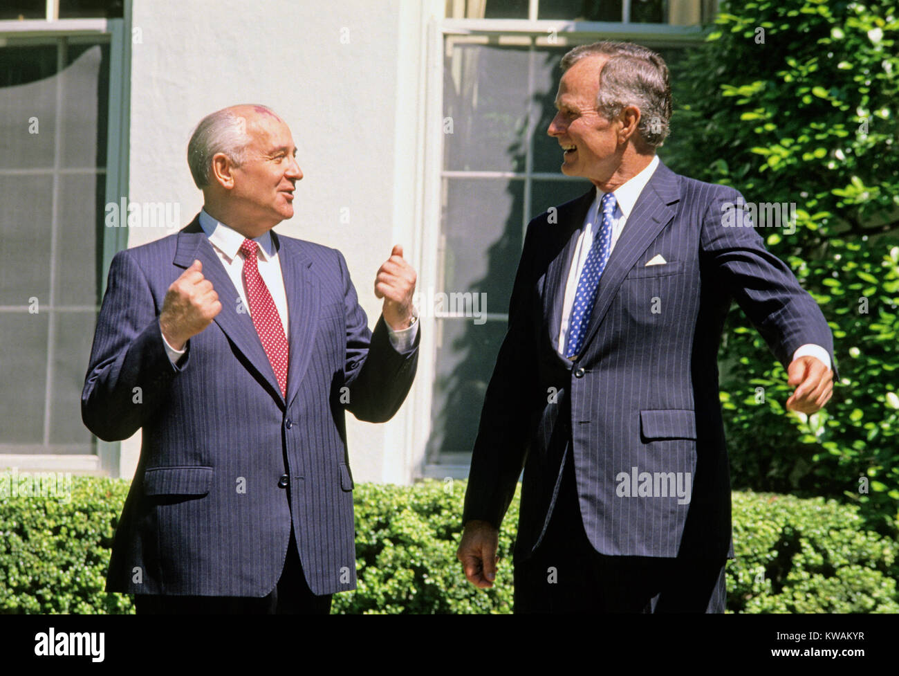 United States President George H.W. Bush, right, in conversation with ...