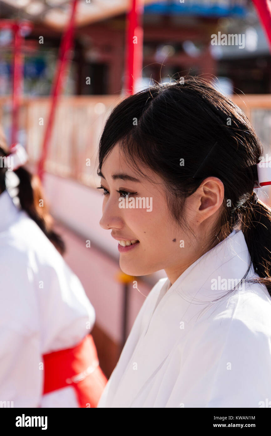 Japan, Kobe, Ikuta Shinto Shrine. Face portrait of Japanese miko ...