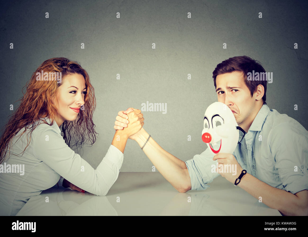 Woman and man having competition in arm wrestling fighting for gender ...