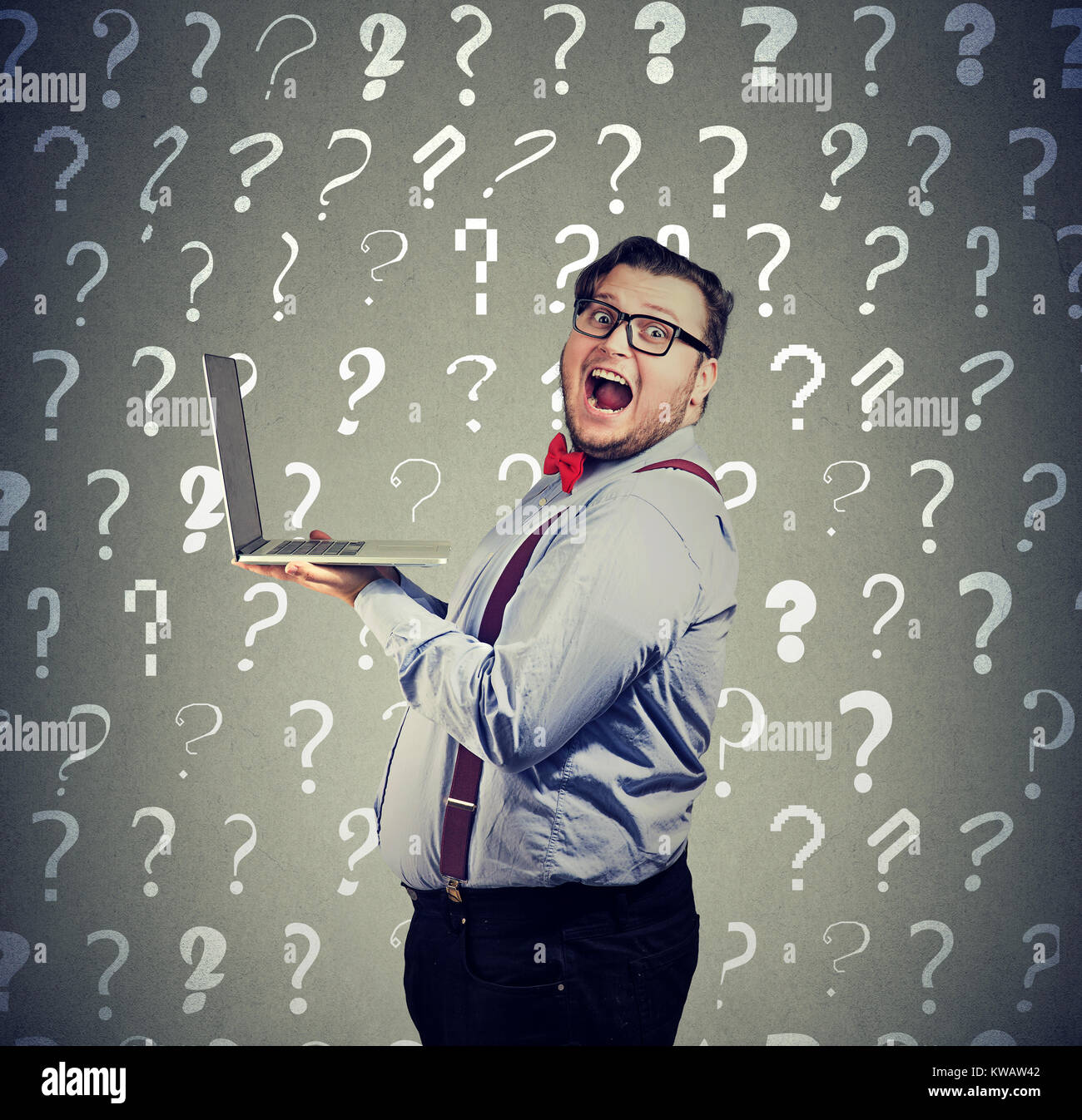 Chubby shocked man holding laptop and looking frustrated at camera ...