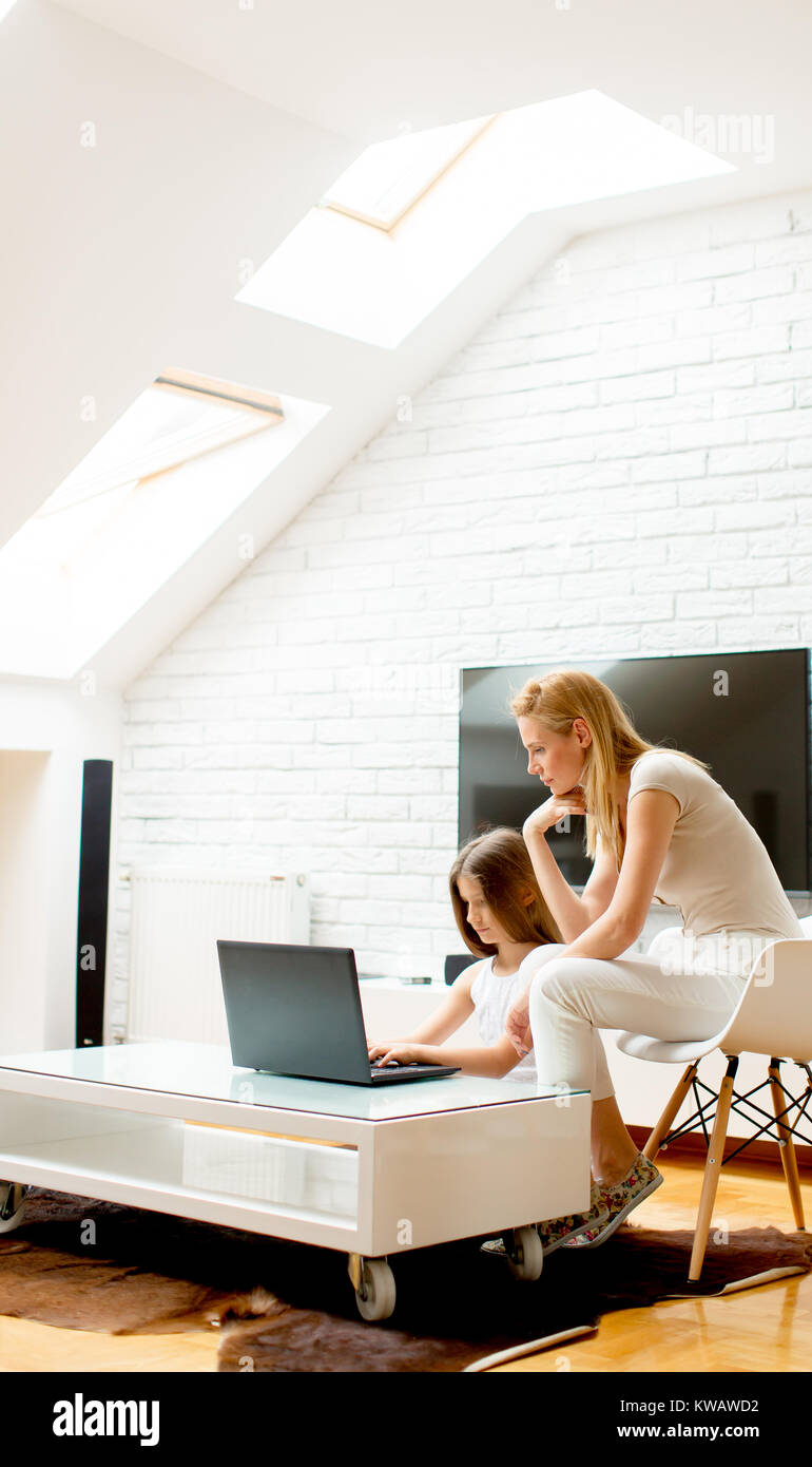Little girl looking at laptop computer with her mom Stock Photo - Alamy