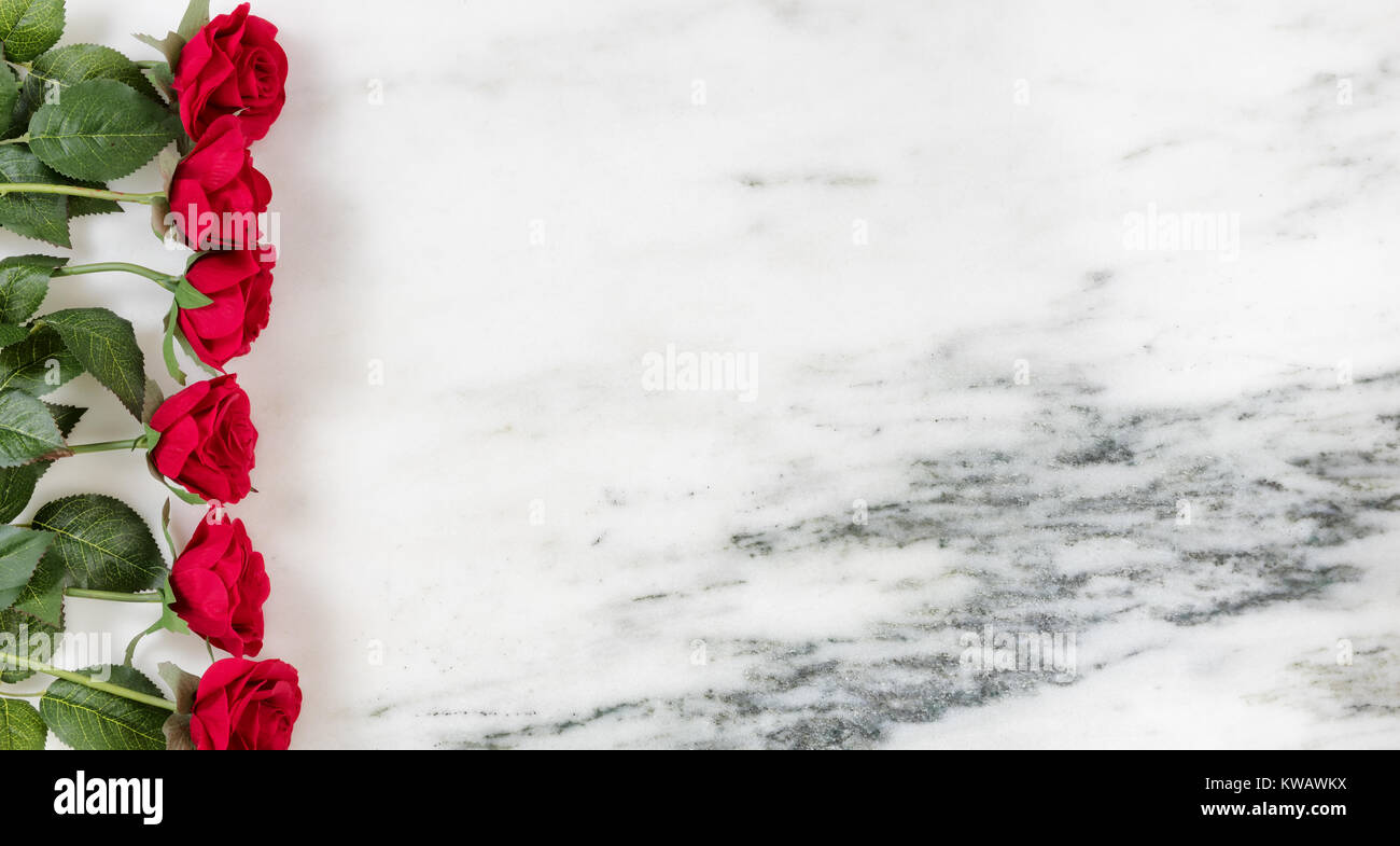 red roses forming left border on marble stone background Stock Photo ...