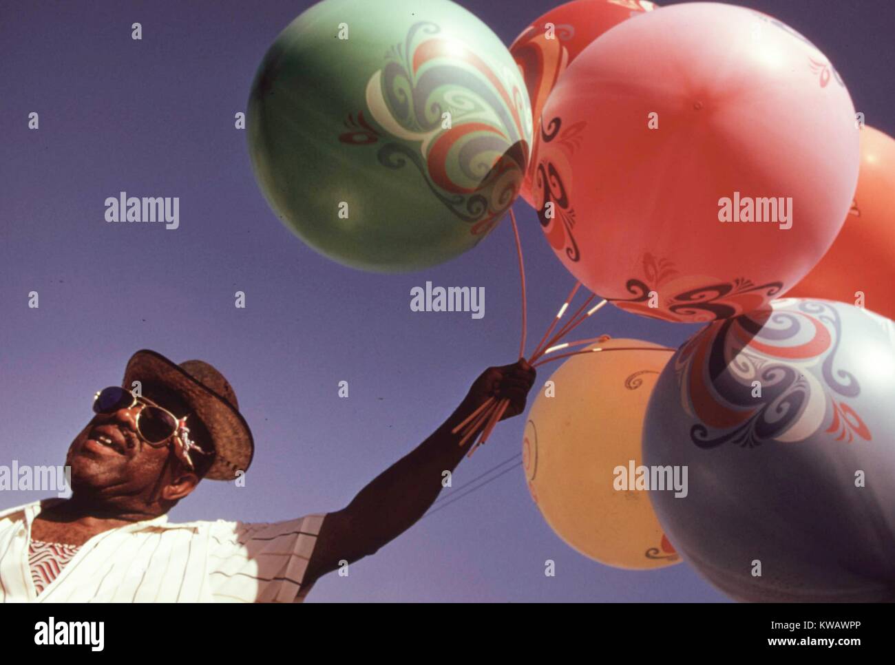 Black man selling balloons hi-res stock photography and images - Alamy