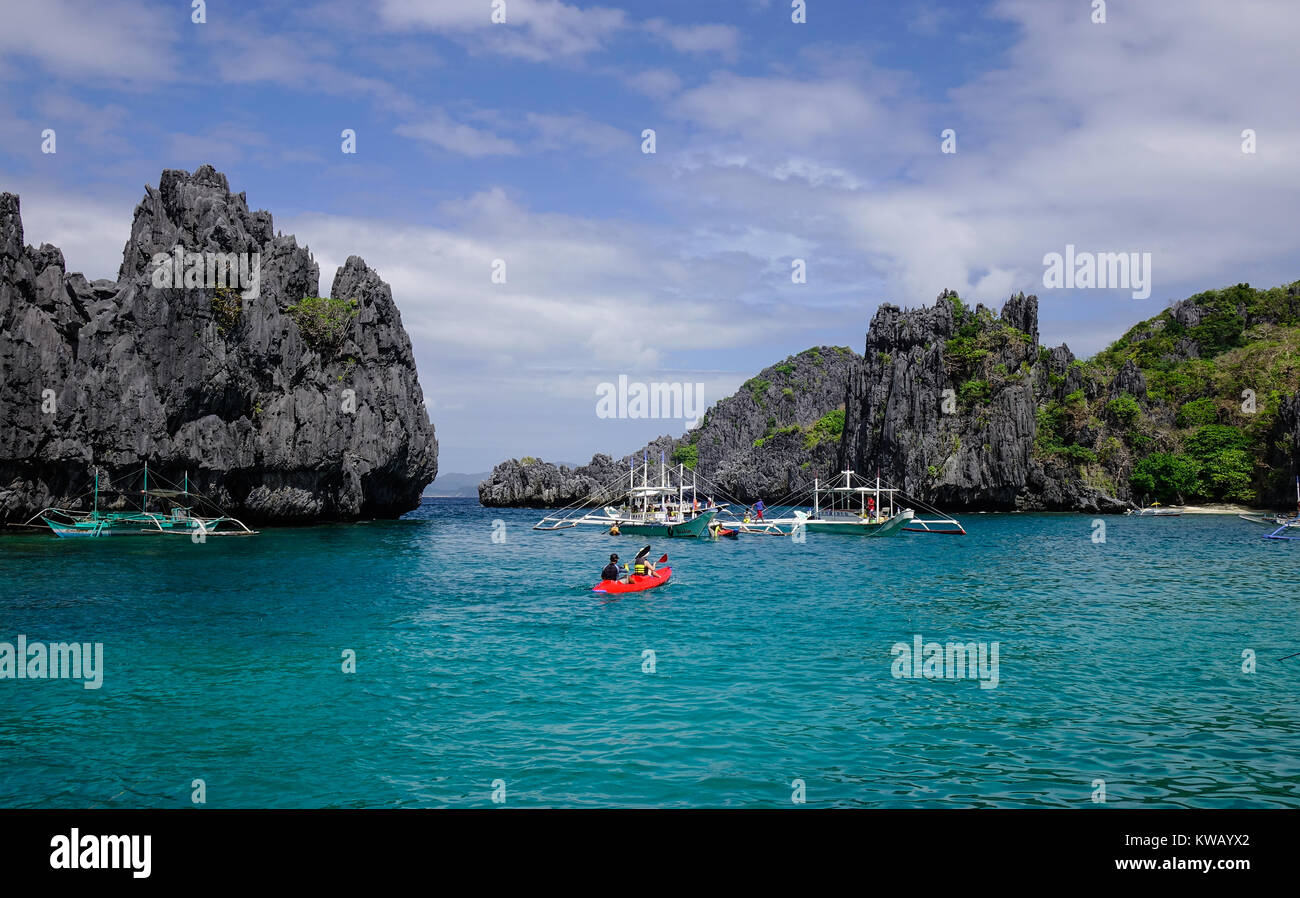 Palawan, Philippines - Apr 5, 2017. People rowing kayaks at blue lagoon ...