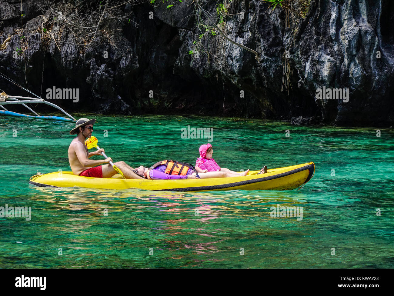 Palawan, Philippines - Apr 5, 2017. A family rowing kayaks at blue ...